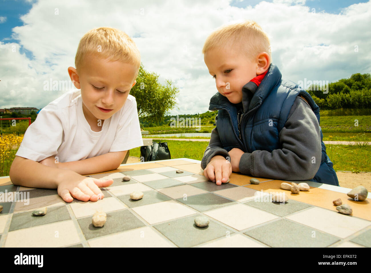 Draughts board game. Little boys clever children kids playing checkers ...