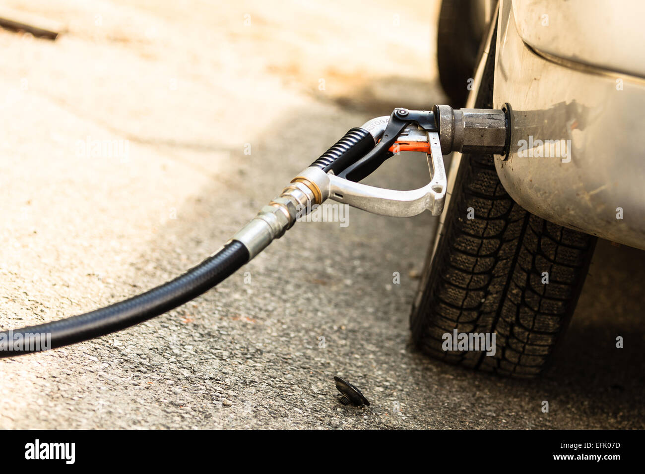 Auto refuel. Car at gas station being filled with fuel, fill up of ...