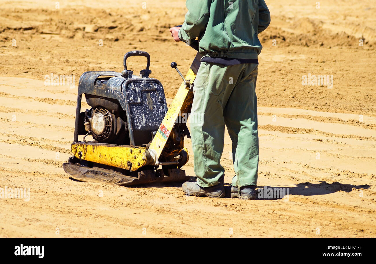 Construction worker is working at the construction site Stock Photo - Alamy