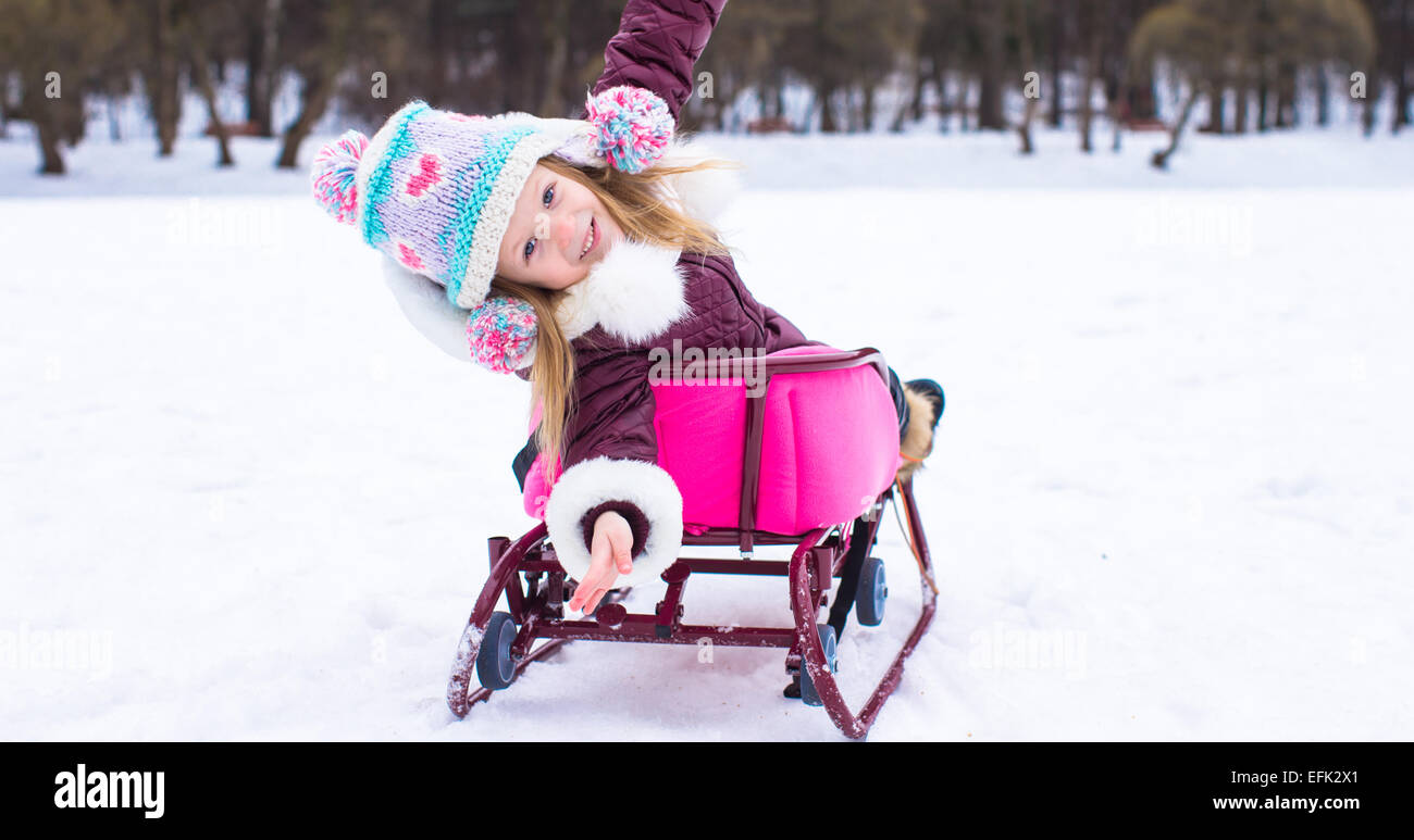 Adorable little happy girl sledding in winter snowy day Stock Photo - Alamy