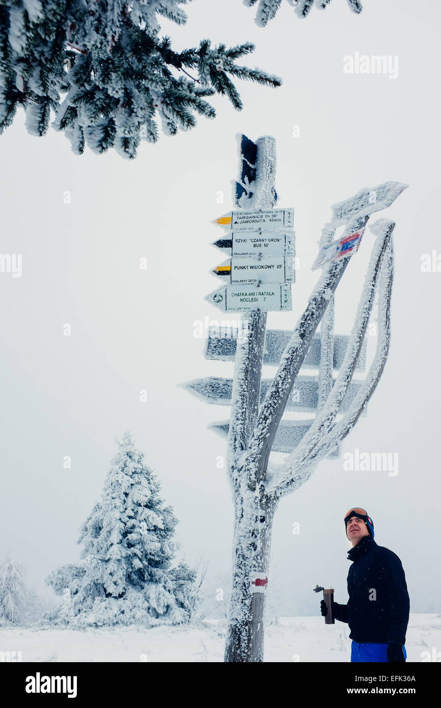 A man reading sign on a trail in Beskidy mountains, Poland Stock Photo ...