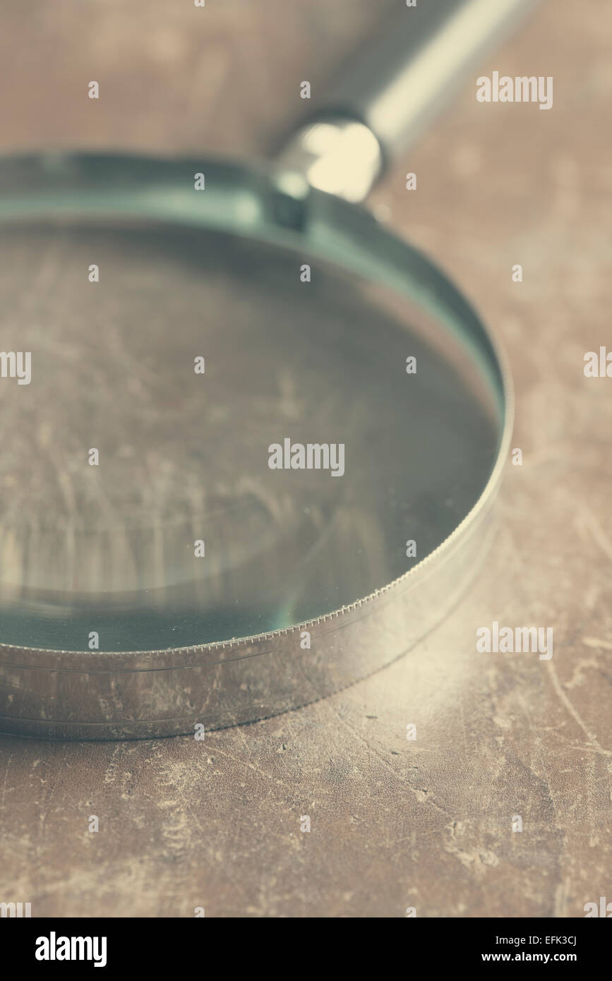 Close up of magnifying glass on weathered surface Stock Photo - Alamy
