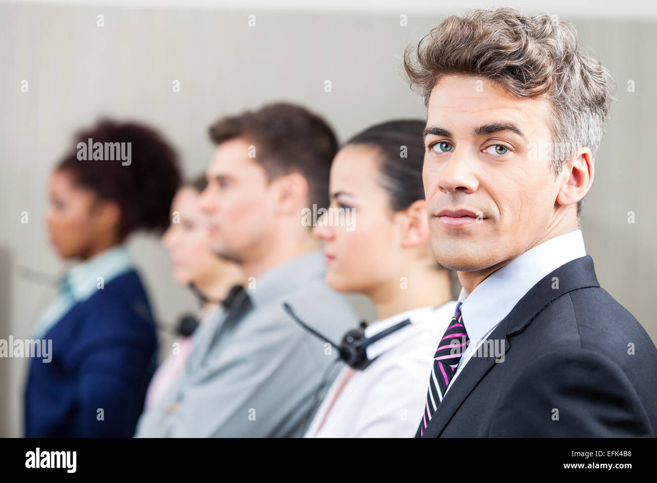 Confident Manager With Employees Standing In Row Stock Photo - Alamy