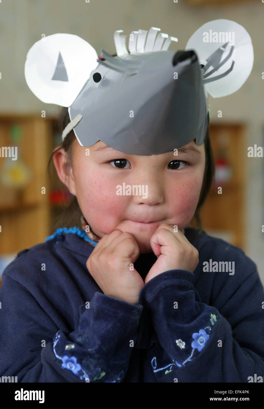 little girl in a kindergarten wearing a mouse paper mask. Mongolia ...