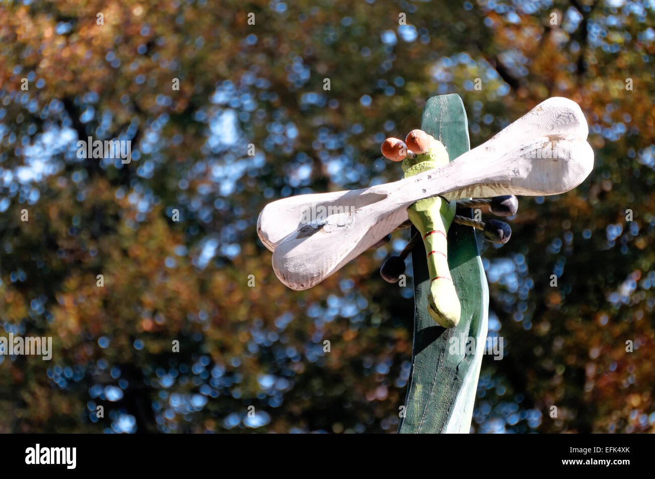 Wooden insect dragonfly on top of a totem pole as decoration for a ...