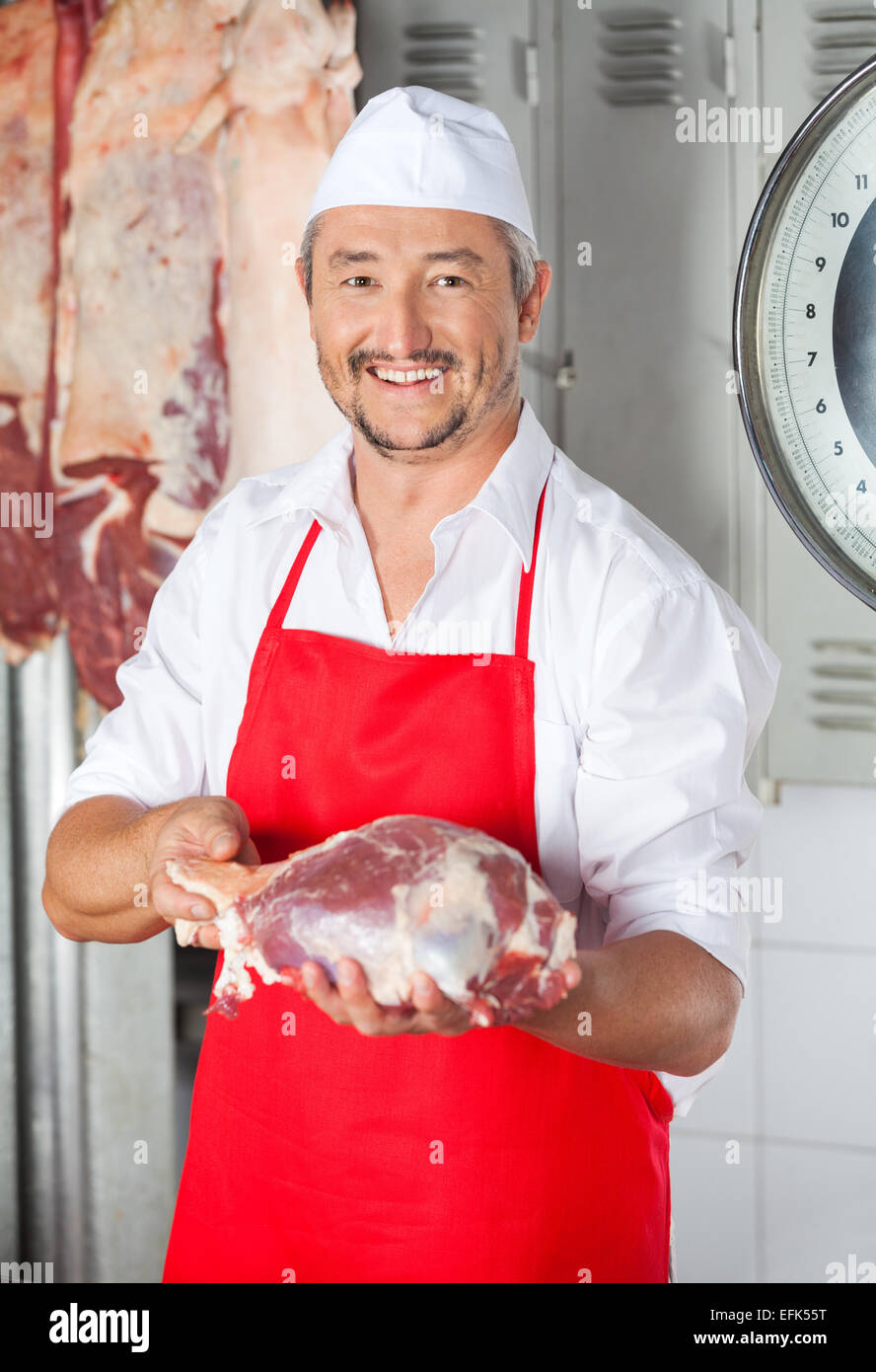 Smiling Male Butcher Holding Meat In Store Stock Photo - Alamy