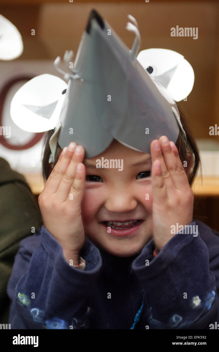 little girl in a kindergarten wearing a mouse paper mask. Mongolia ...