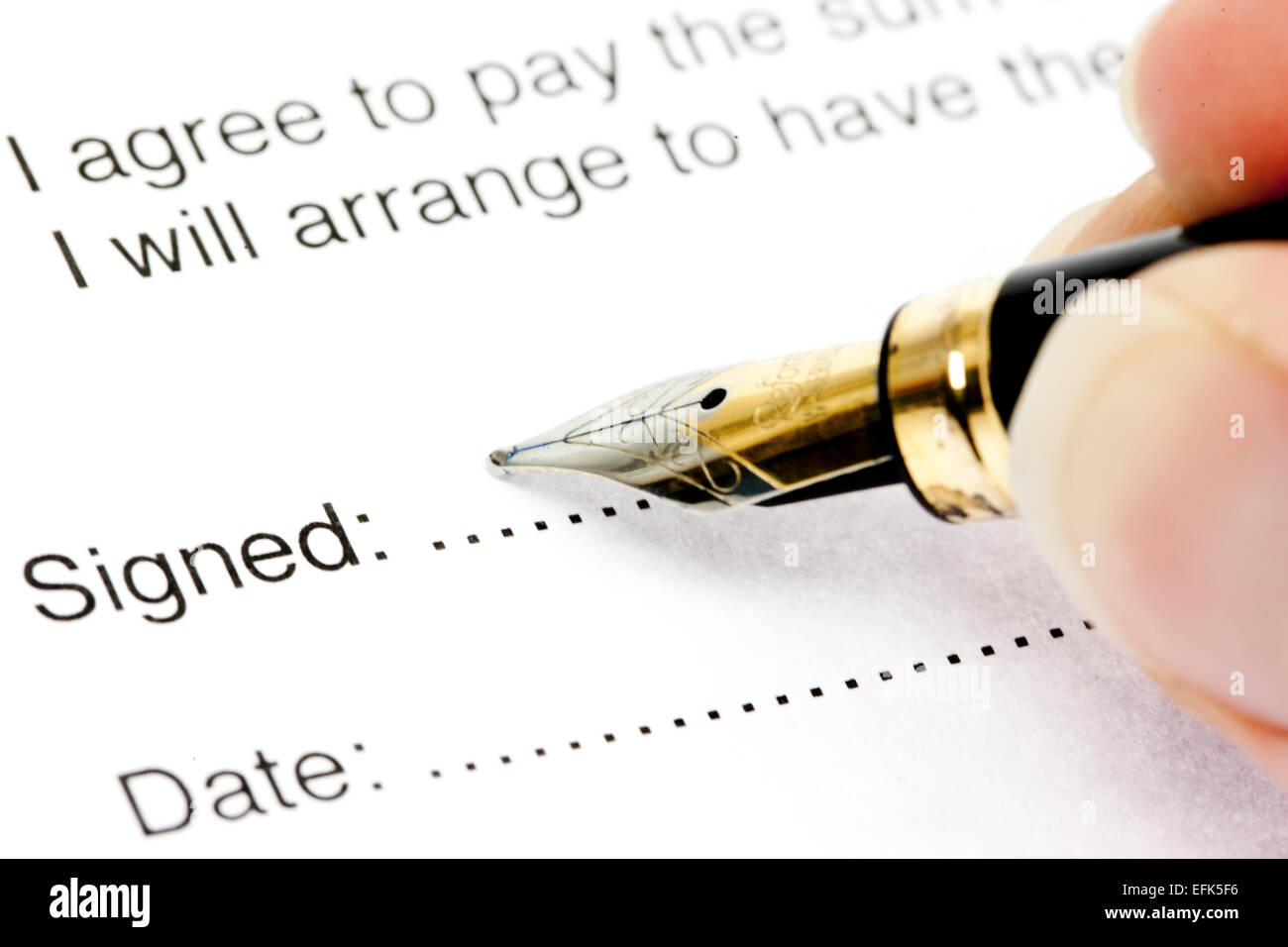 A fountain pen about to sign on the dotted line Stock Photo - Alamy