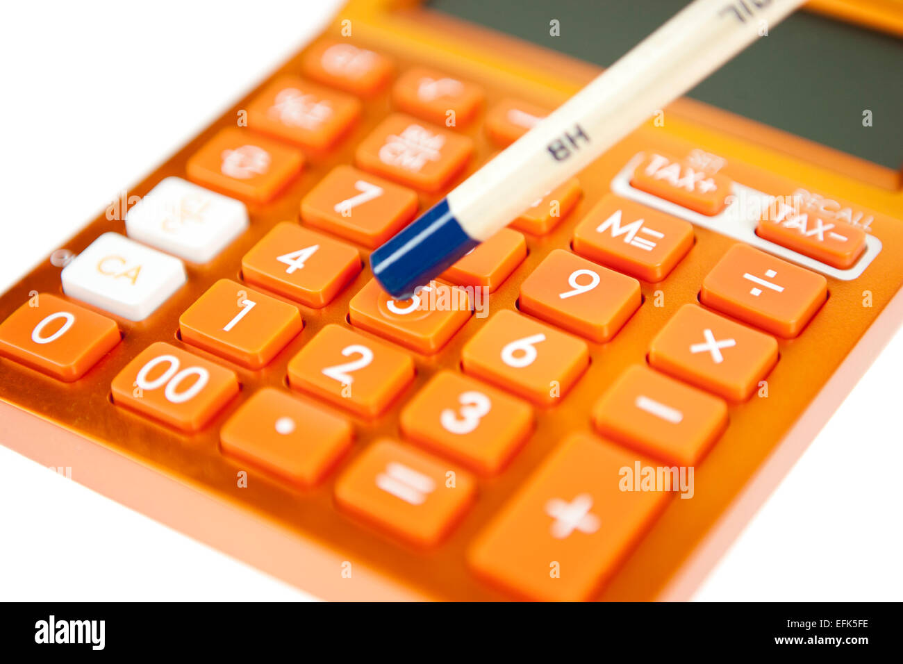 An orange calculator with a pencil resting on the number 5 button Stock ...
