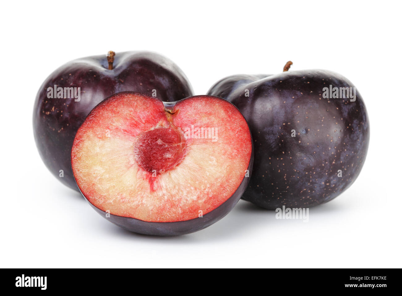 Three whole red plums on white background hi-res stock photography and ...