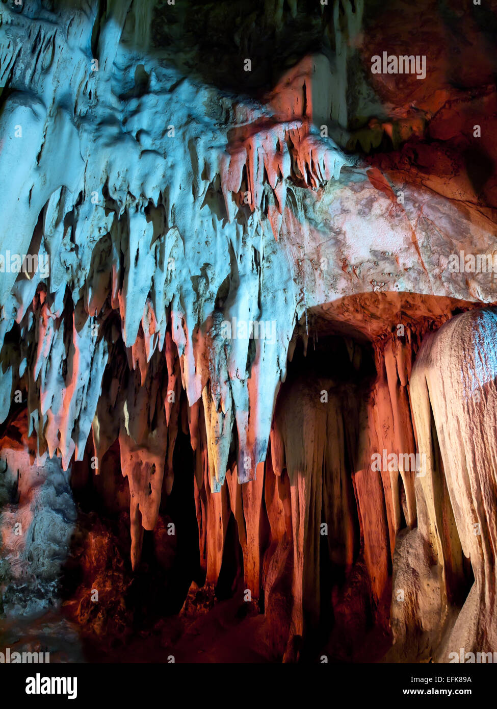 Stalactite wall illuminated with color light in Tham Khao Bin cave ...