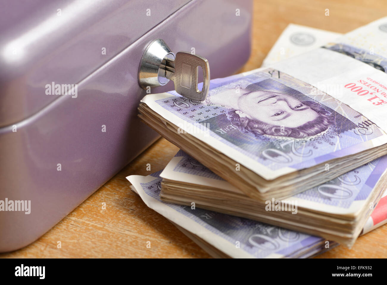 Cash box with stacks of twenty pound notes Stock Photo - Alamy