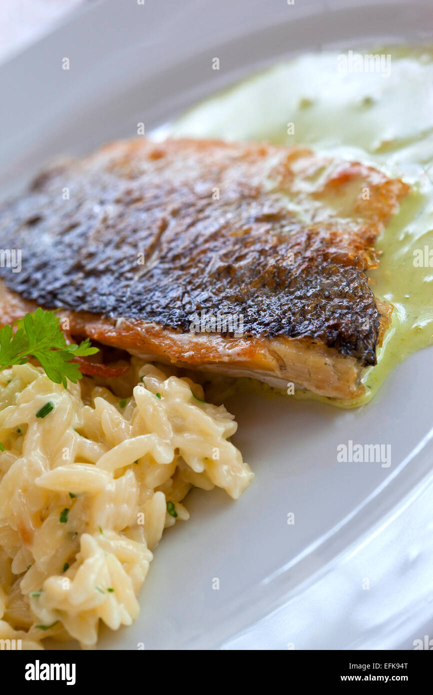 Cod fillet and rice on a plate Stock Photo - Alamy