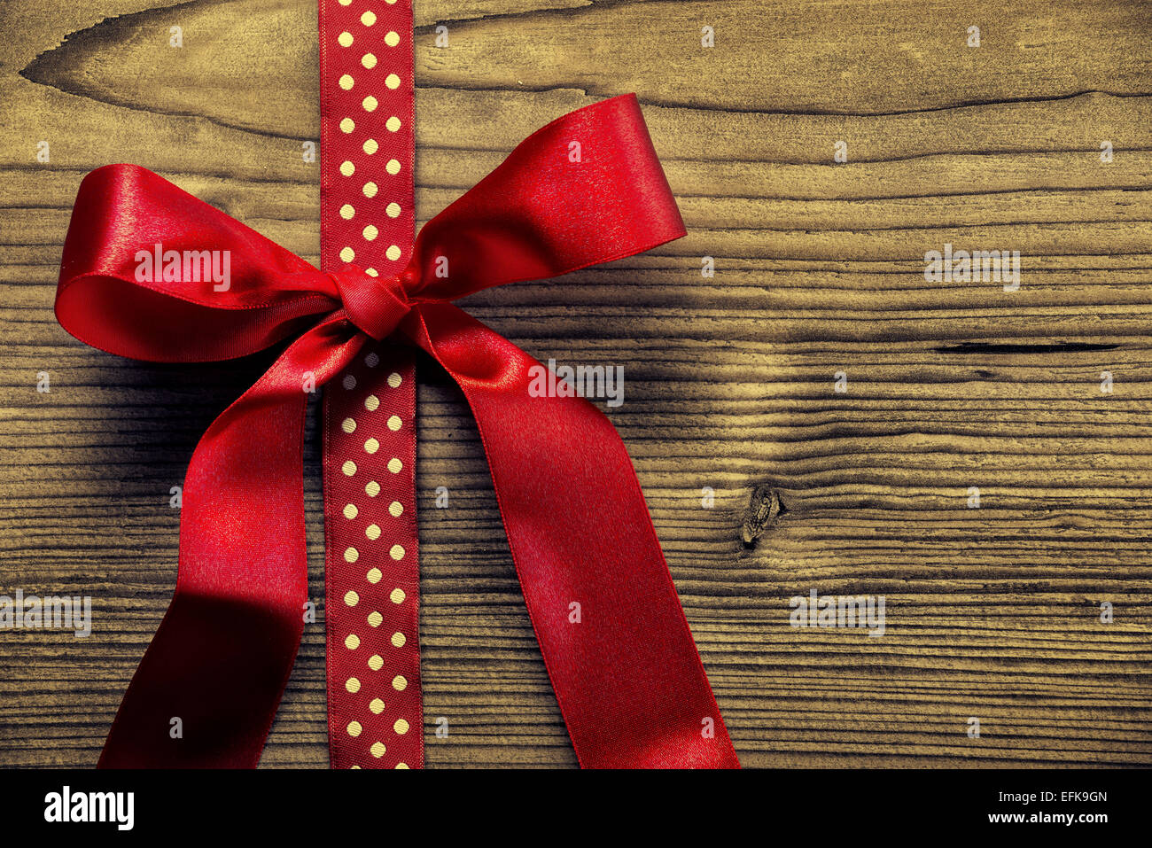 In love wallpaper - Big red bow on wood background Stock Photo - Alamy
