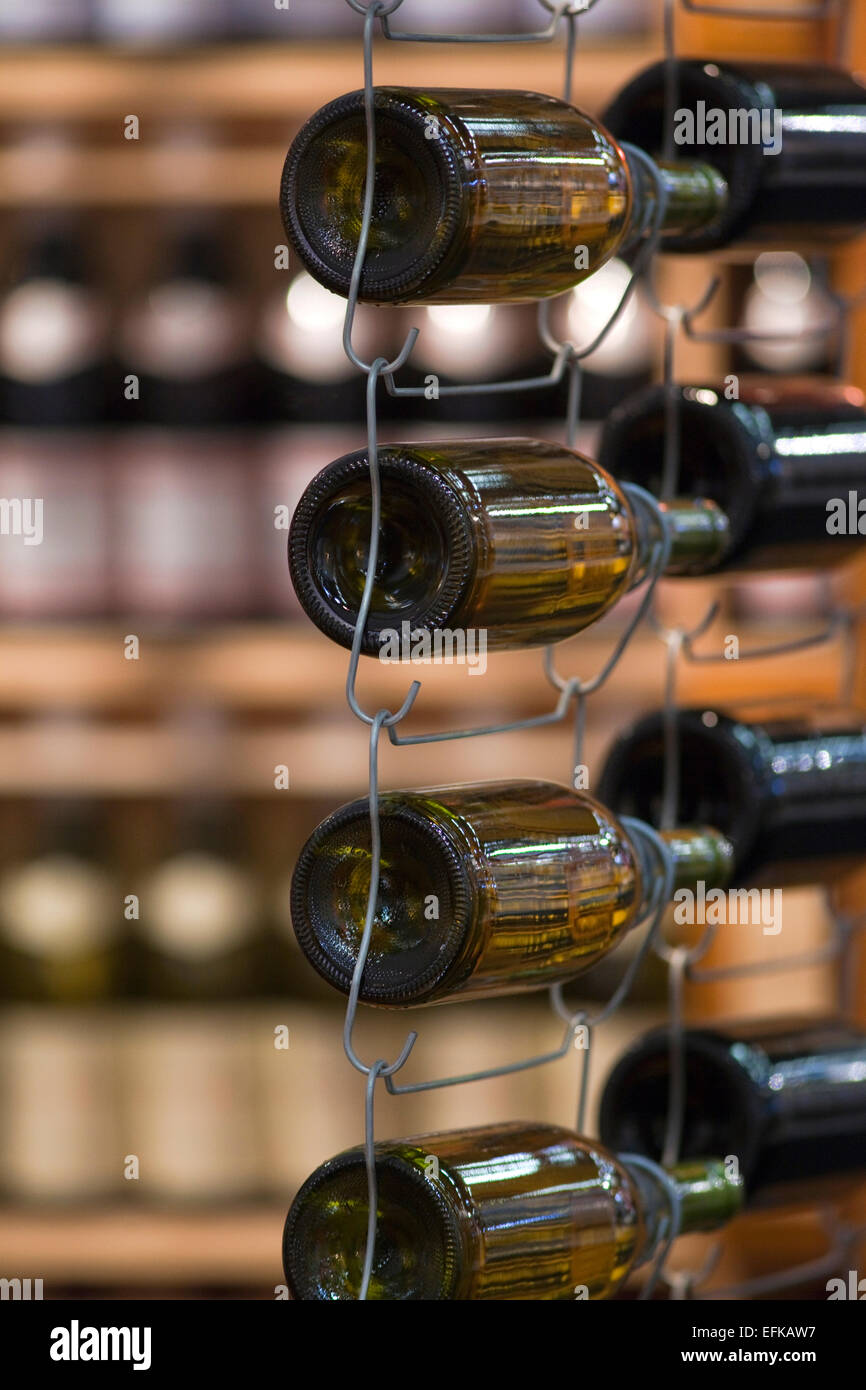 Bottles of wine hanging in a winery Stock Photo - Alamy