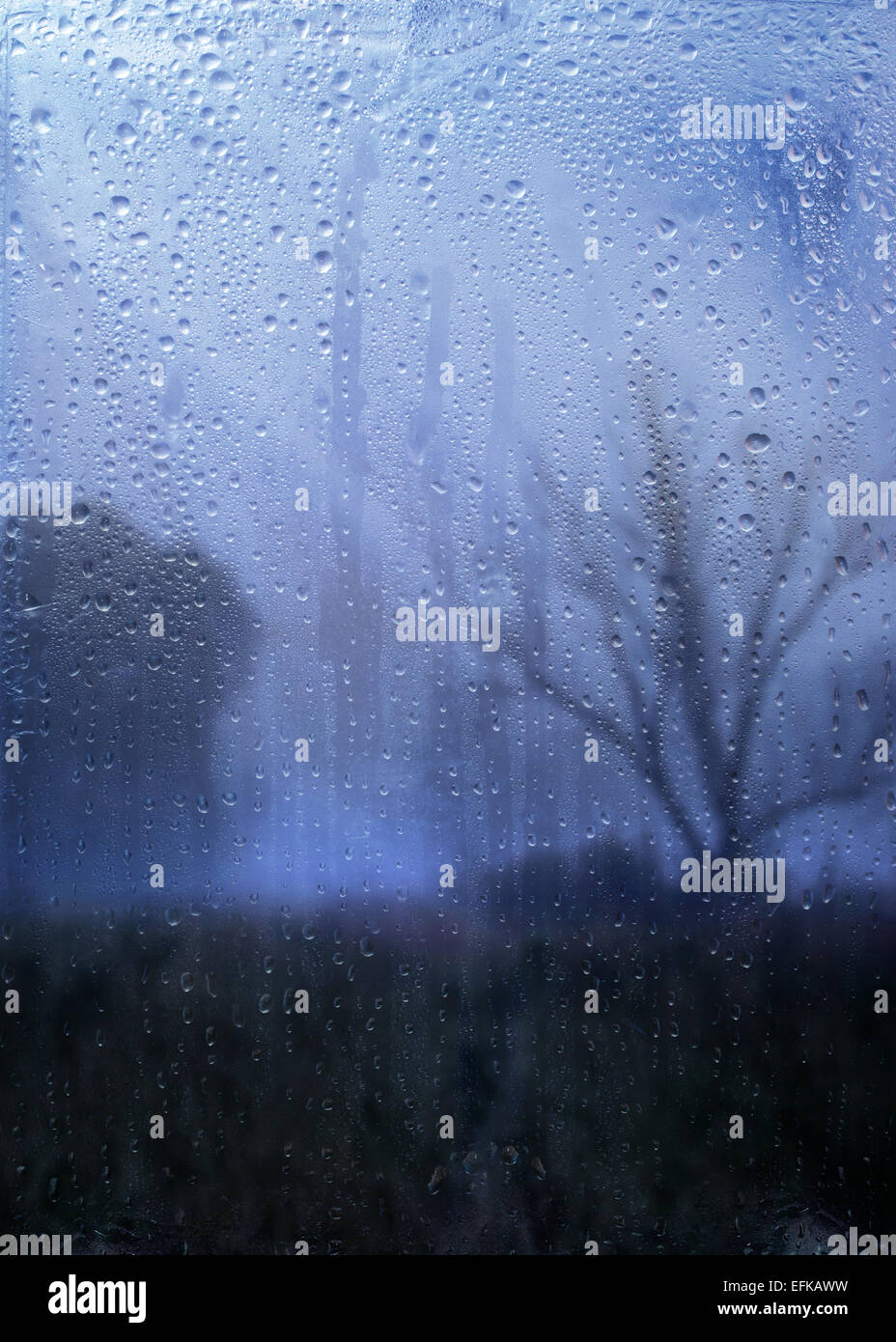 Rainy autumn landscape through a window with raindrops. autumnal mood ...