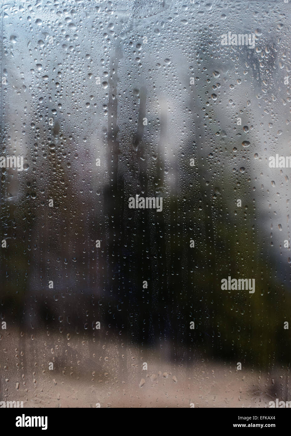 Rainy autumn landscape through a window with raindrops. autumnal mood ...