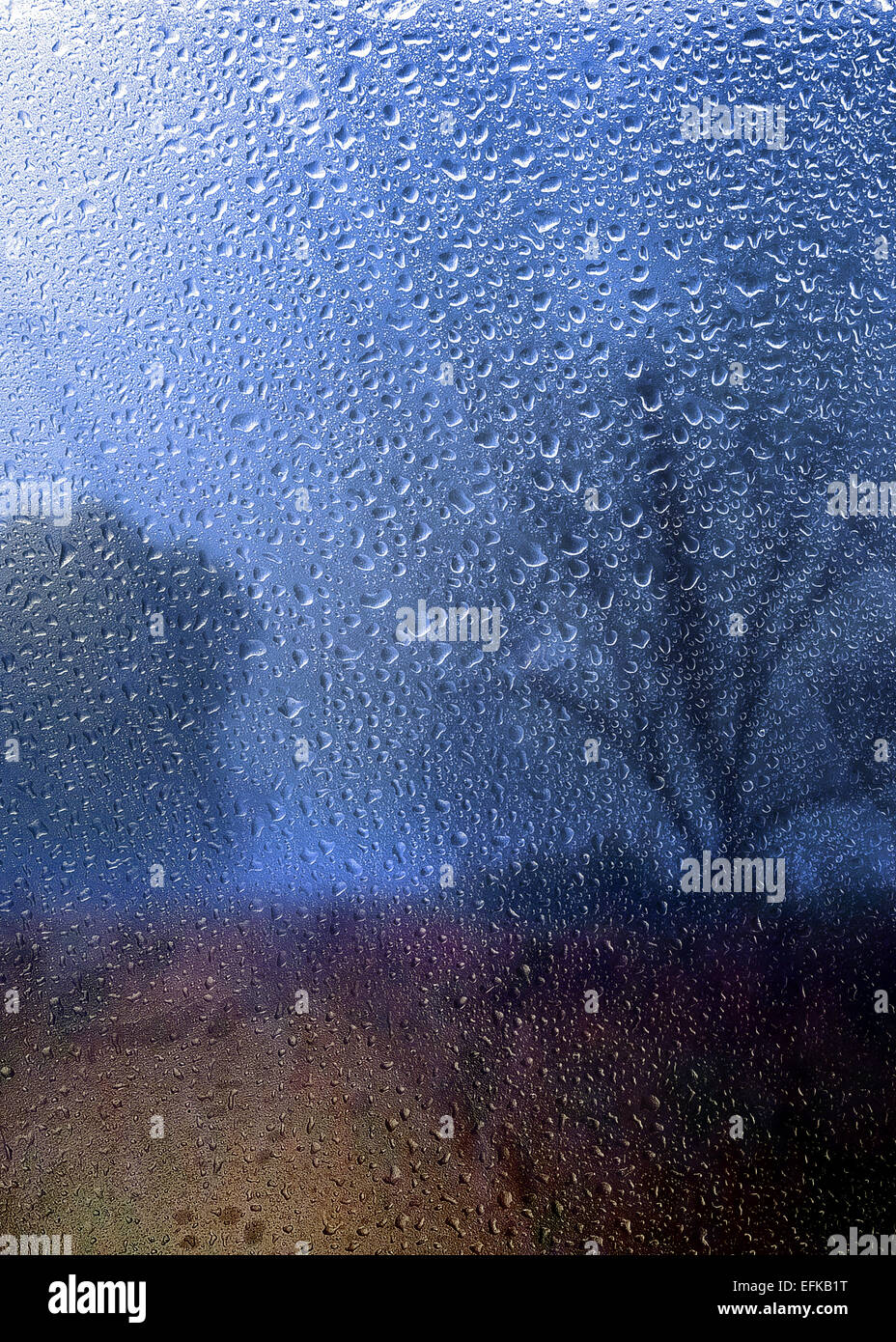 Rainy autumn landscape through a window with raindrops. autumnal mood ...