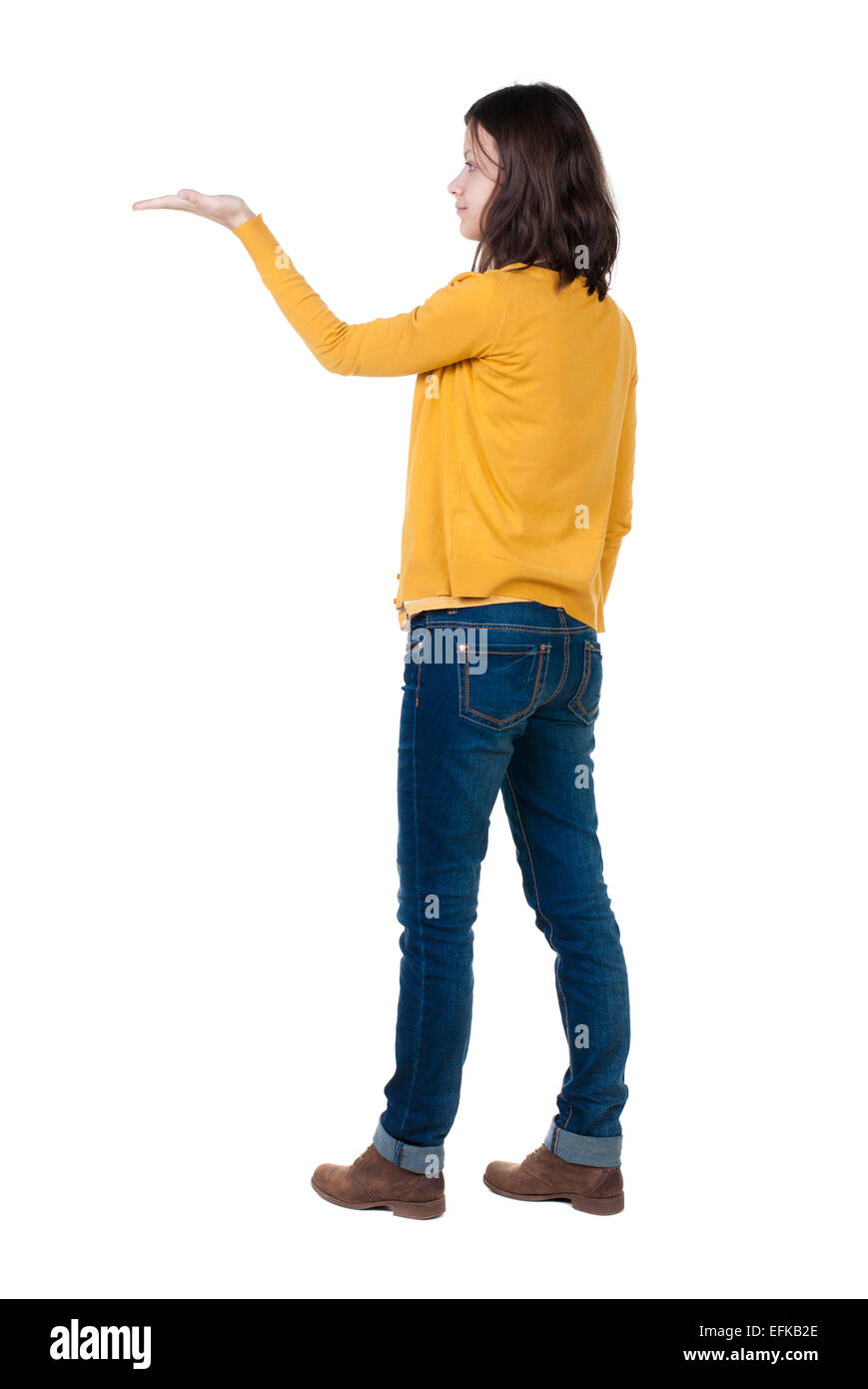 Back view of Beautiful business woman in yellow pulover looking at wall ...