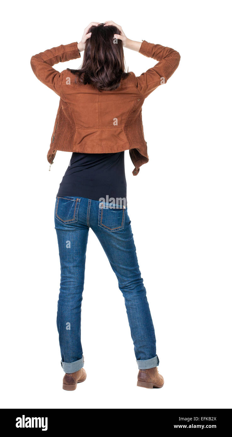 Back view of shocked woman in blue jeans. girl hid his eyes behind his ...
