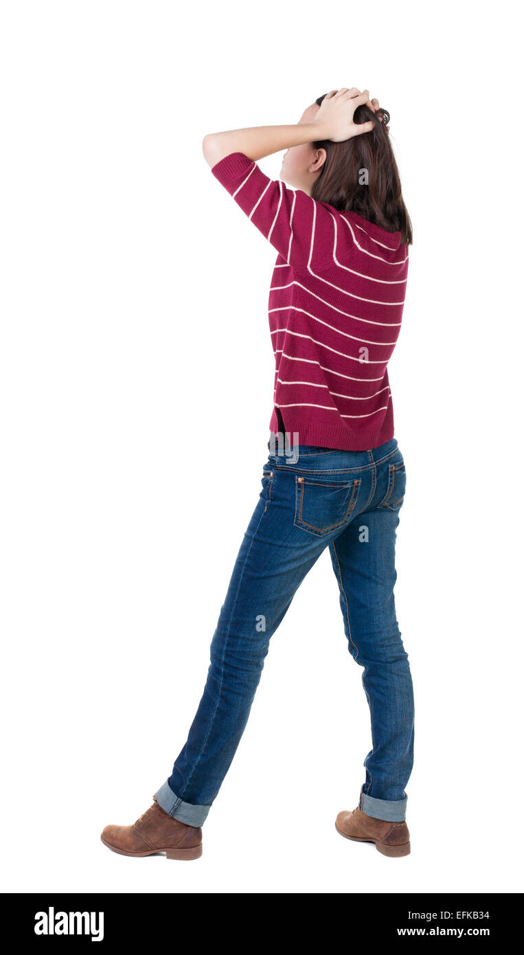 Back view of shocked woman in blue jeans. girl hid his eyes behind his ...