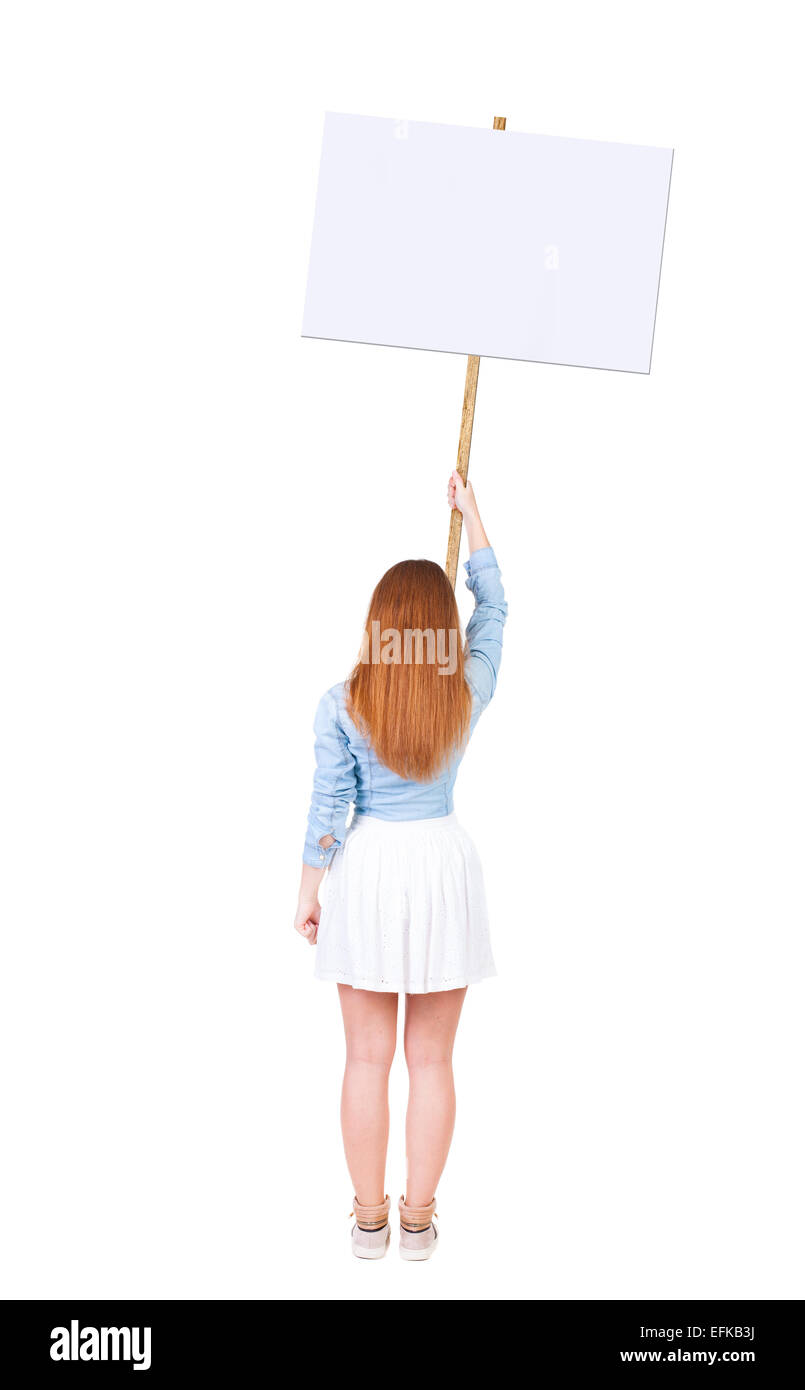Back view of woman showing a sign board. young redhead girl holds ...
