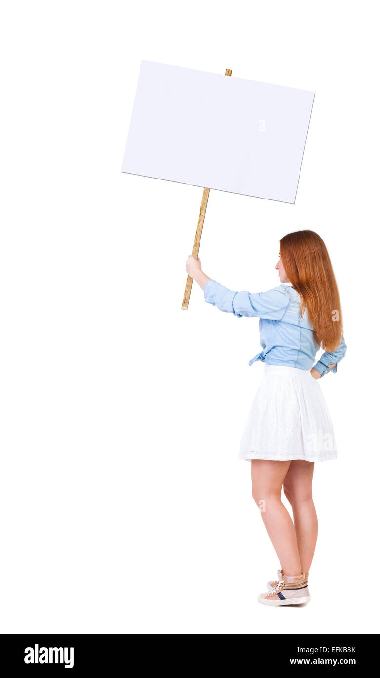 Back view of woman showing a sign board. young redhead girl holds ...