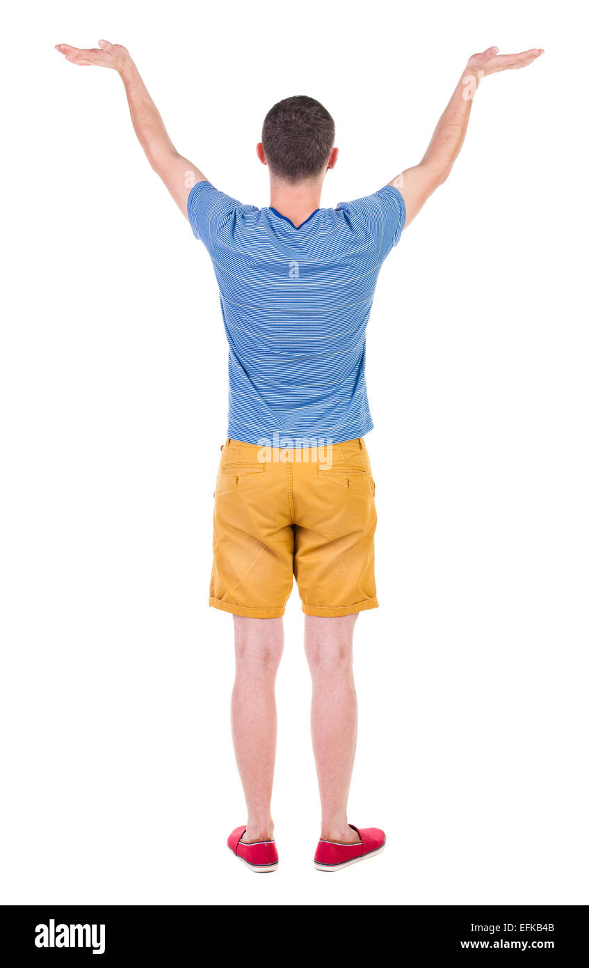 Back view of Beautiful man in jeans looking at wall and Holds hand up ...