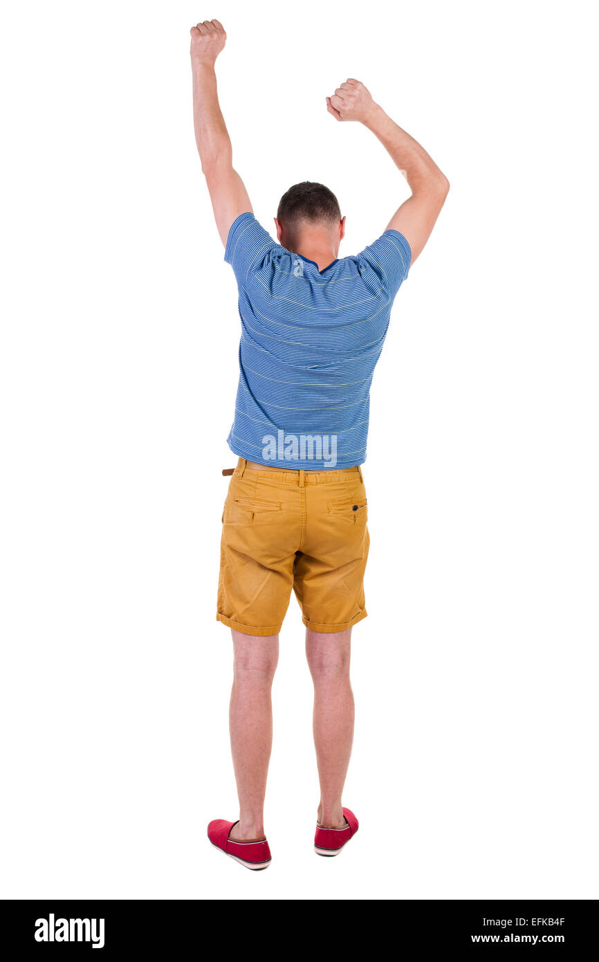 Back view of joyful man celebrating victory hands up. Rear view people ...