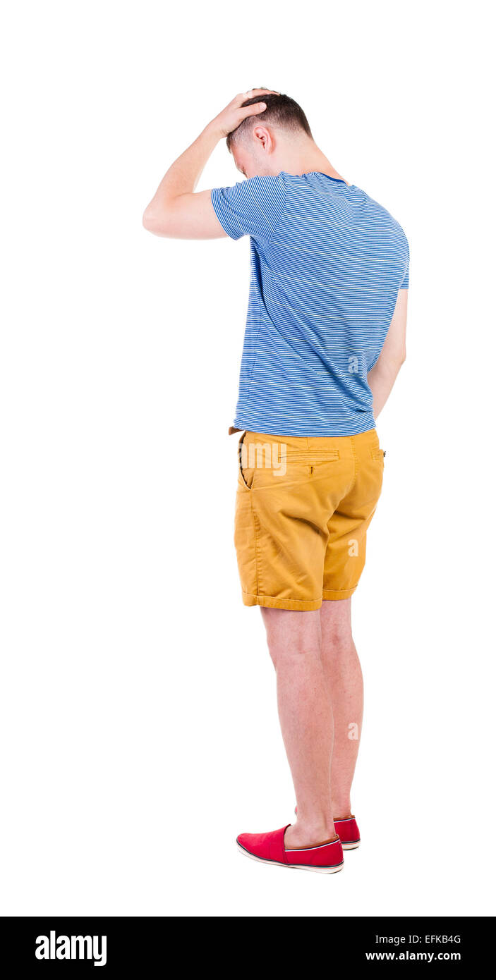 Back view of angry young man in shorts and t-shirt. Rear view. isolated ...