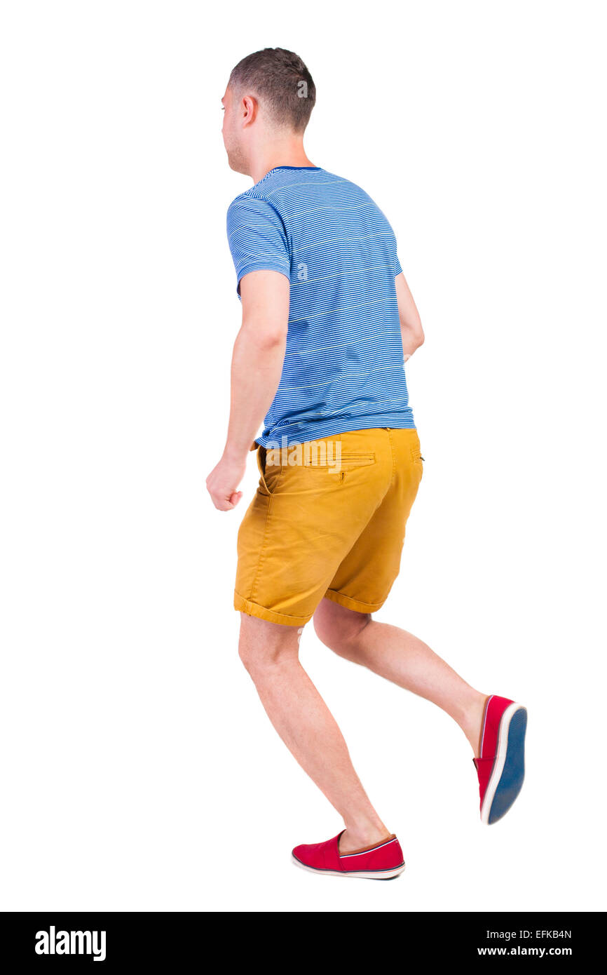 Back view of running man in t-shirt and shorts. Walking guy in motion ...