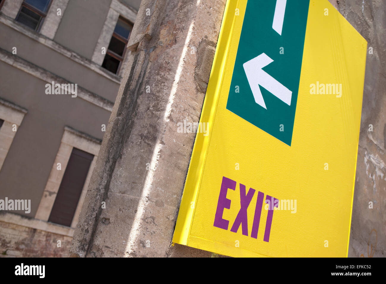 Exit sign on a wall Stock Photo - Alamy