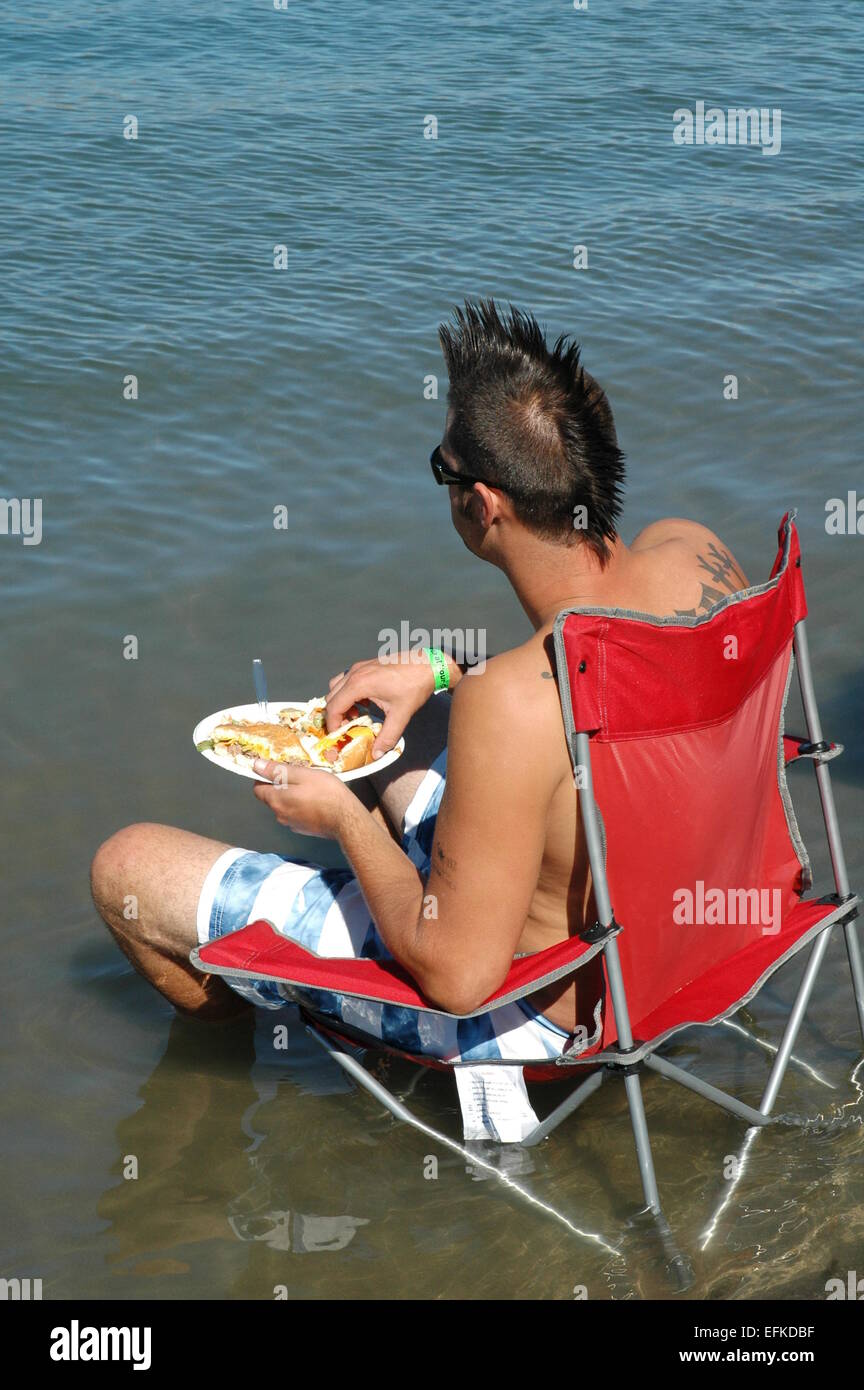 Man eating lunch at lake Stock Photo - Alamy
