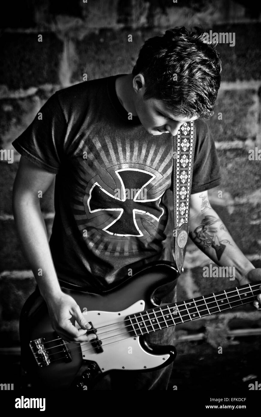 Man playing bass guitar in industrial grunge environment Stock Photo ...
