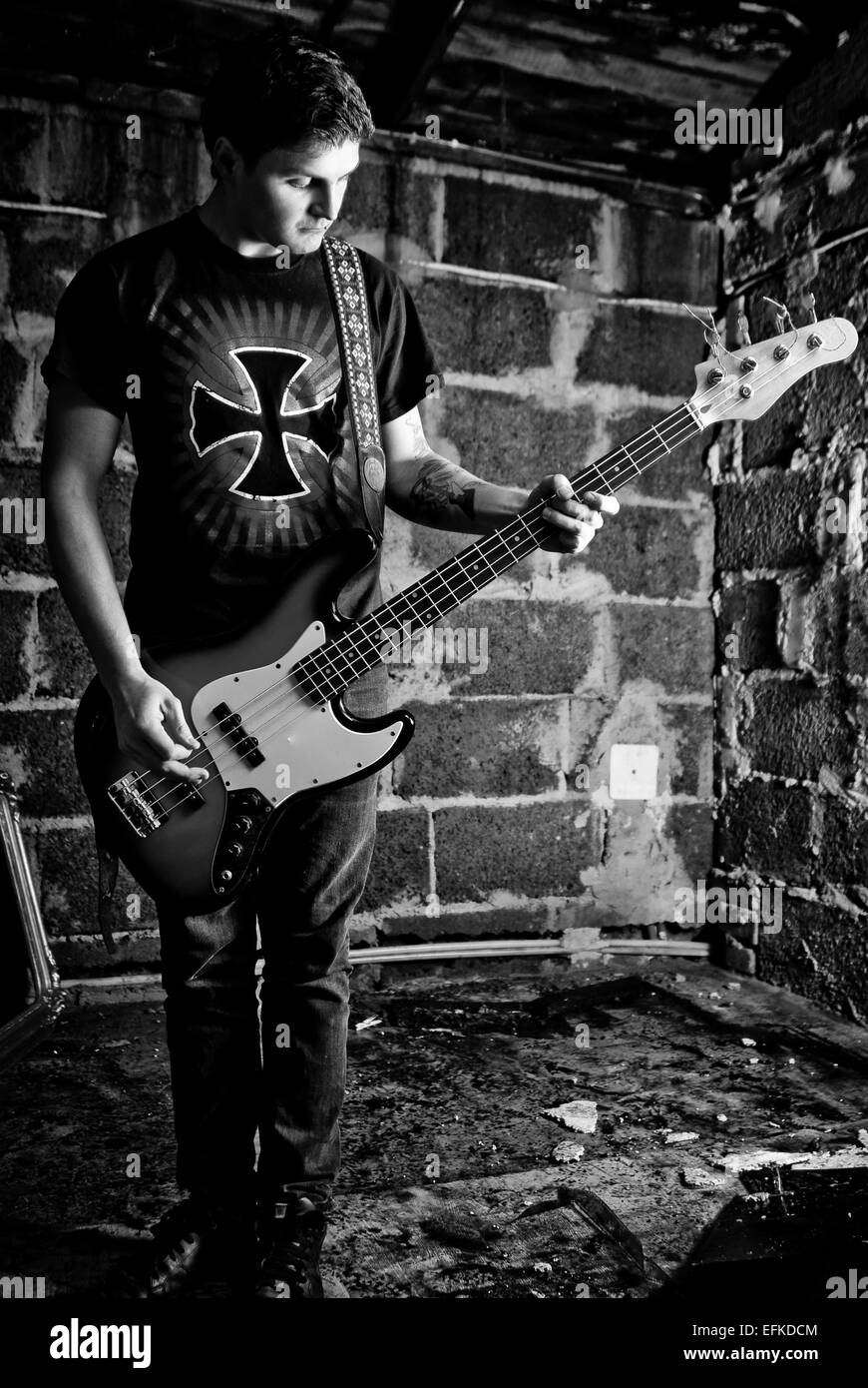 Man playing bass guitar in industrial grunge environment Stock Photo ...