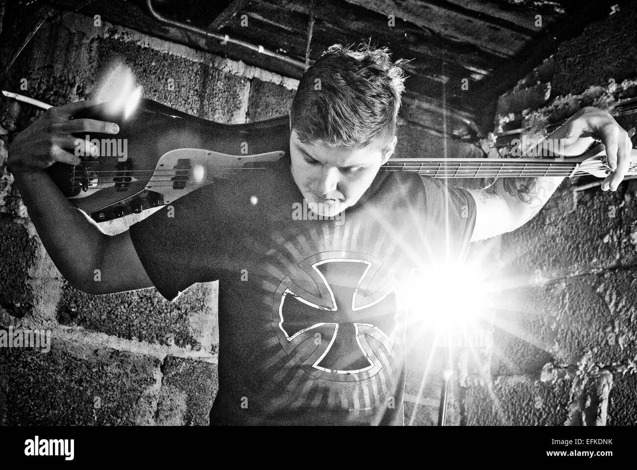 Man playing bass guitar in industrial grunge environment Stock Photo ...
