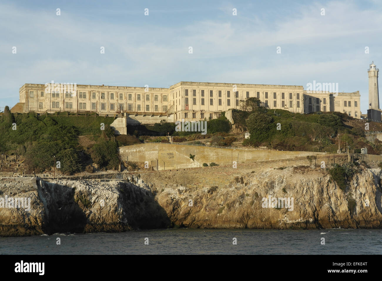 Blue sky view from ferry boat Main Prison Cell Block and Lighthouse on ...