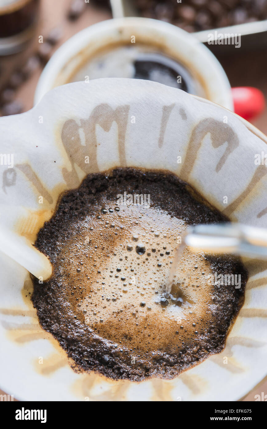 Making brewed coffee from steaming filter drip style Stock Photo - Alamy