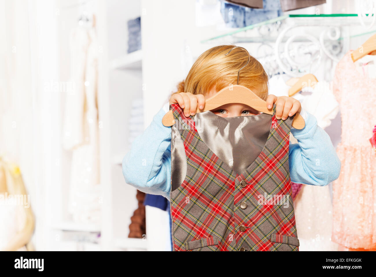 Boy hiding behind shelf hi-res stock photography and images - Alamy
