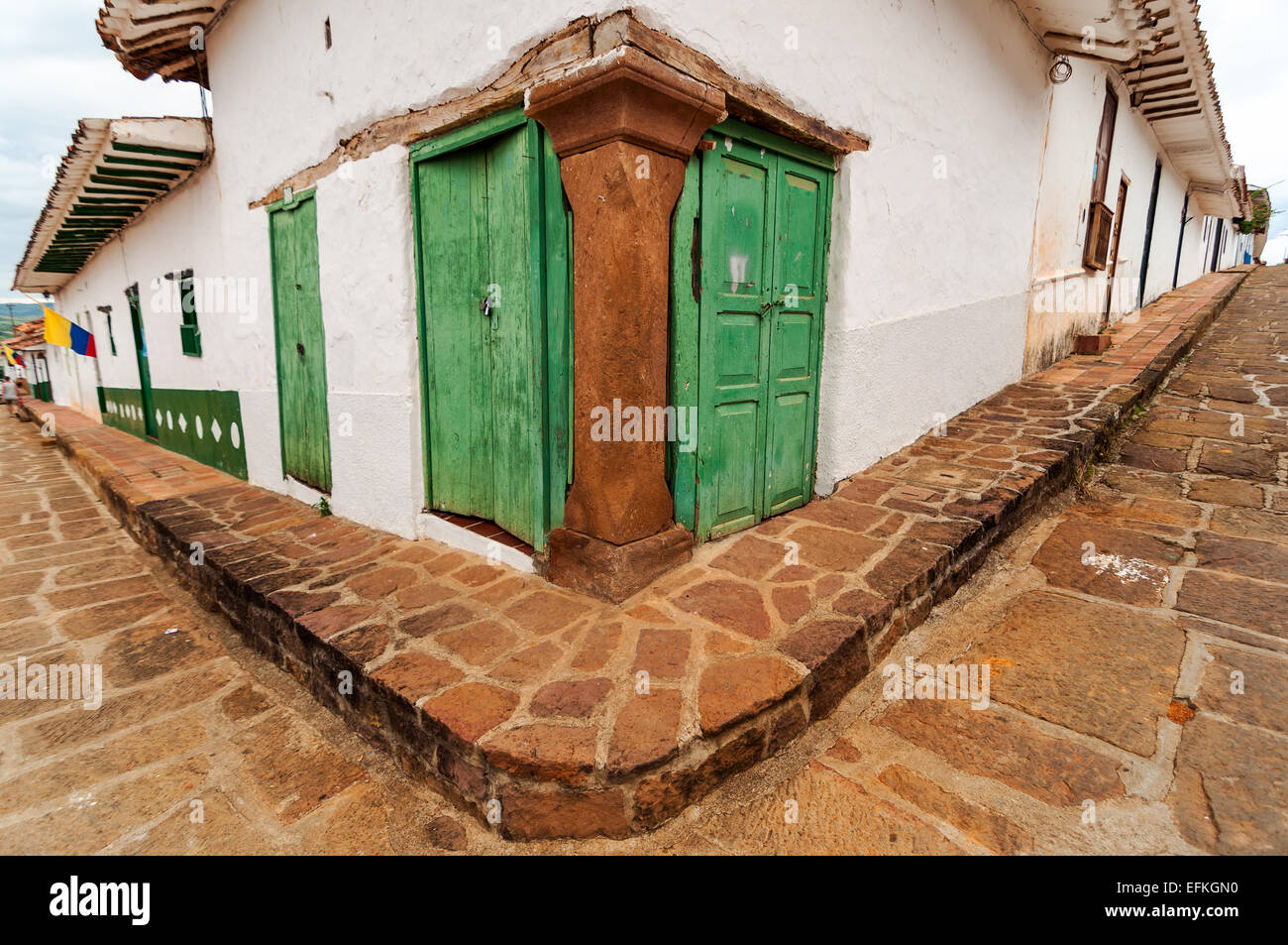 Street corner with an old colonial building with green doors in ...