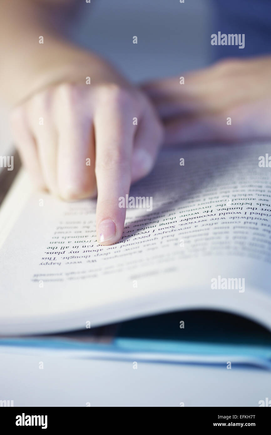 Close up of girls finger pointing on reading book Stock Photo - Alamy