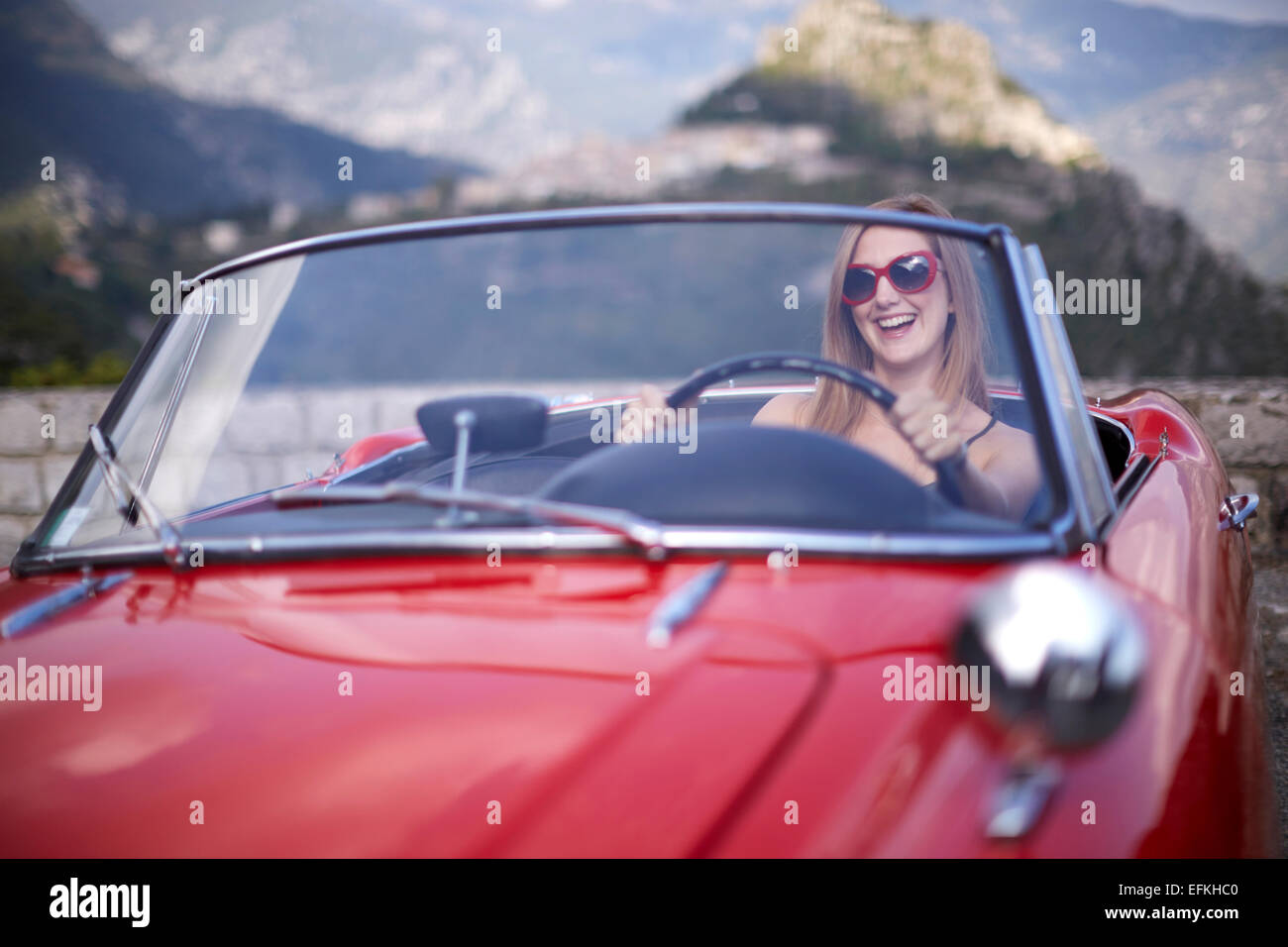 Young woman driving a vintage classic sports car in the South of France ...