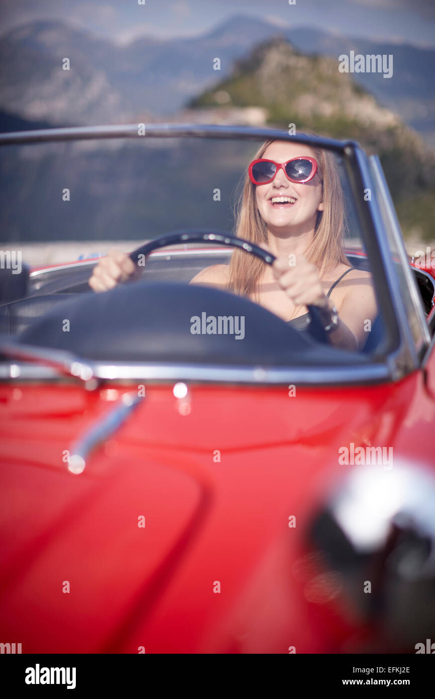Young woman driving a vintage classic sports car in the South of France ...