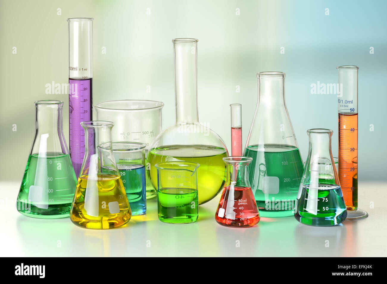 Laboratory glassware on white table and window in background - With ...