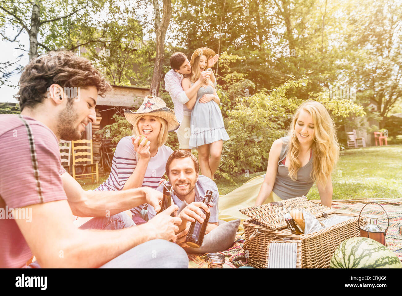 Friends drinking beer in garden Stock Photo - Alamy
