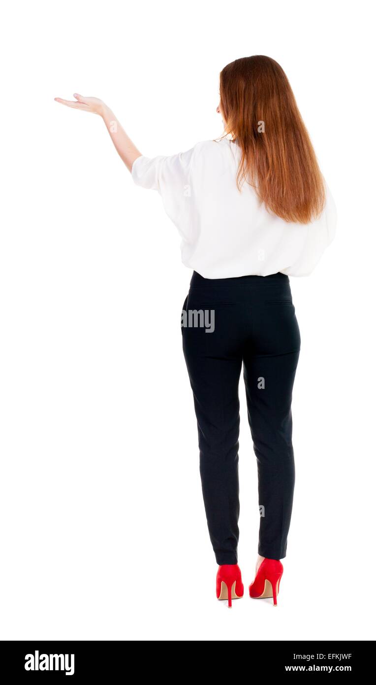 Back view of Beautiful business woman in suite looking at wall and ...