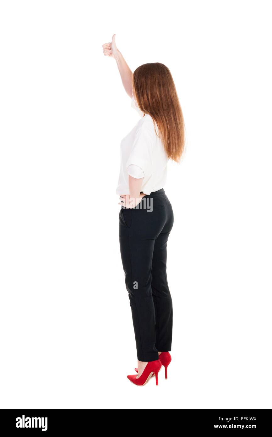 back view of standing young redhead business woman showing thumb up ...