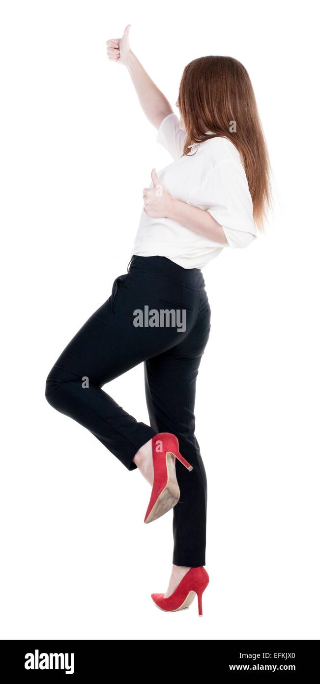 back view of standing young redhead business woman showing thumb up ...