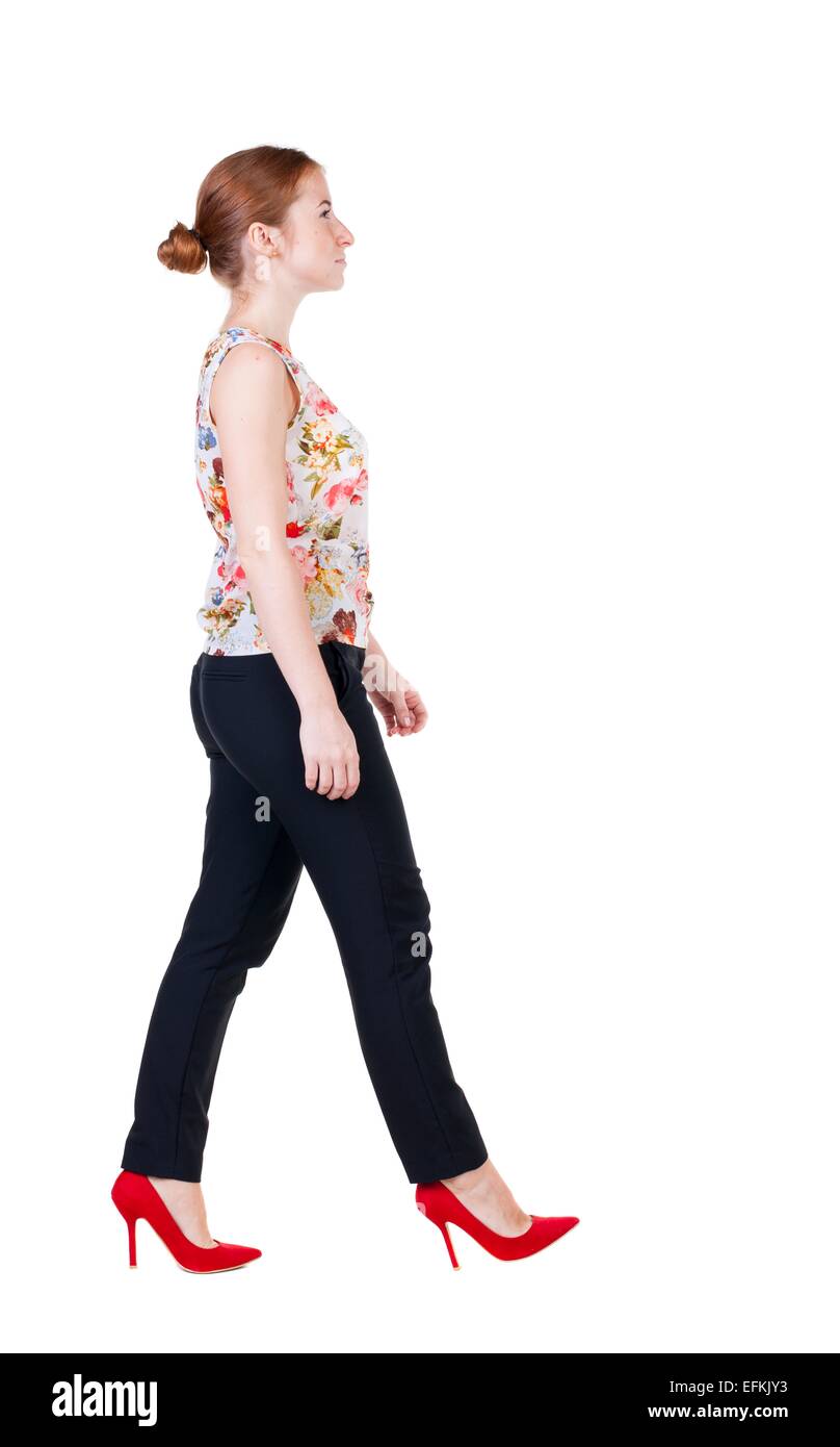 walking red head business woman. back view. going young girl in suit ...