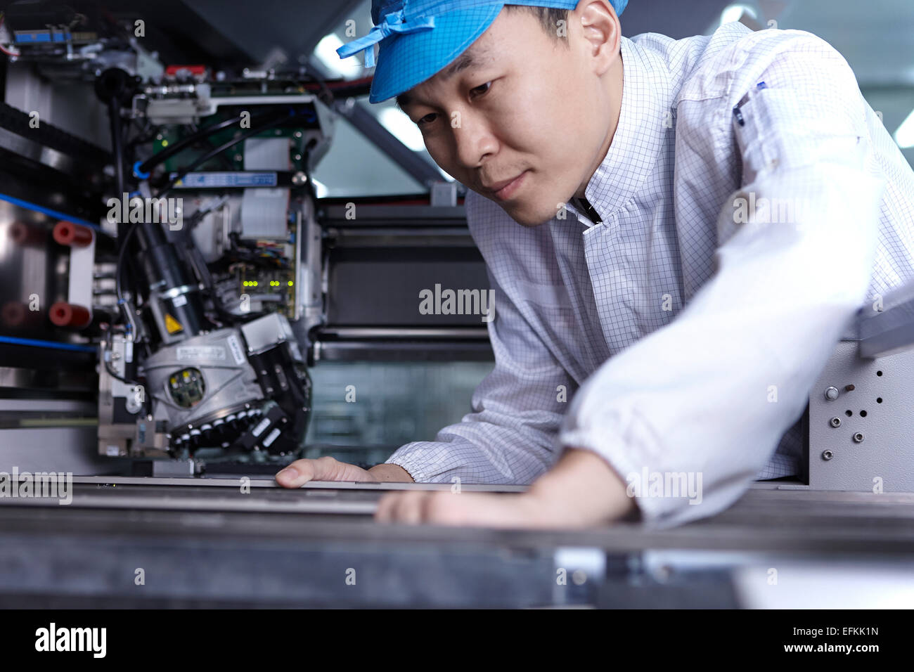 Worker using machinery in factory that specialises in creating ...